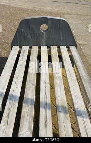 Welsh slate and wooden bench on quayside in porthmadog north wales uk ...