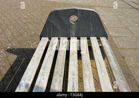 Welsh slate and wooden bench on quayside in porthmadog north wales uk ...