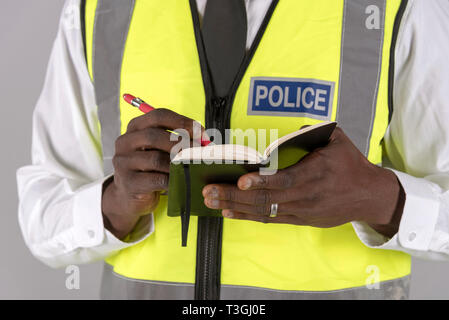 Police officer taking notes in front of police car Stock Photo - Alamy