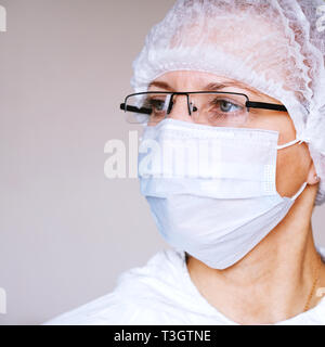 Lab technician, medic. Jar for analysis. On the face of a protective ...