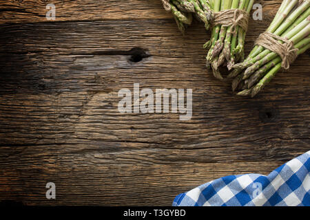 Fresh green asparagus on old oak table Stock Photo - Alamy