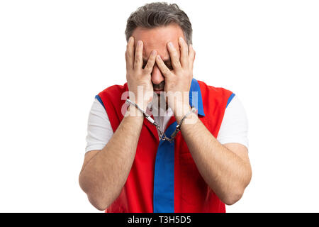 Handcuffed man covering his face with his hands. Arrested and ...