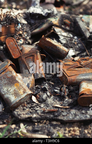 Burnt tin cans in the remains of a fire Stock Photo - Alamy