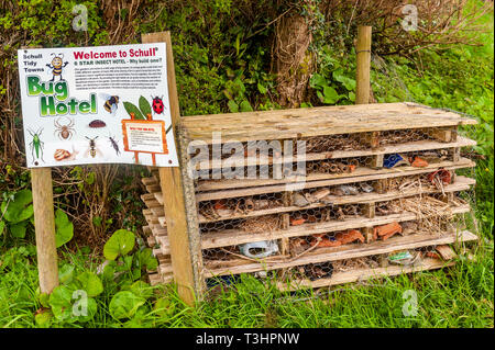 A bug hotel for insects made from old wooden pallets in a wild corner ...