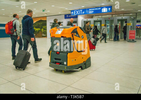 Passengers admire the autonomous cleaning machine Swingobot 2000, as ...