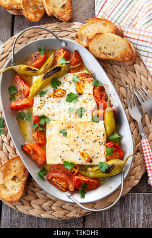 Gratinated feta cheese with tomatoes and chillis Stock Photo - Alamy