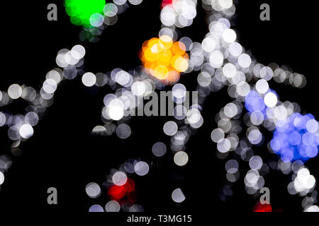 Unfocused abstract red bokeh on black background. defocused and blurred ...