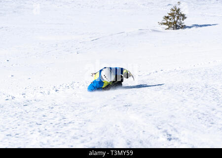 Climber practices self arrest with ice ax at mountaineering school ...