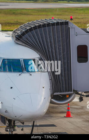 Jetway connected to the airplane for boarding passengers. Boarding ...
