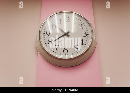 Wall clock show eight o'clock on white marble texture. Office clock ...