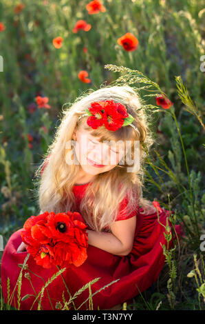 beautiful blond girl with red corn poppy flower Stock Photo - Alamy