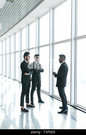 Group of business people discuss something inside office Stock Photo ...