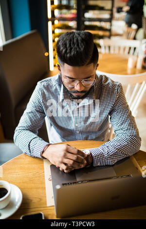 Handsome businessman browsing net during coffee break Stock Photo - Alamy