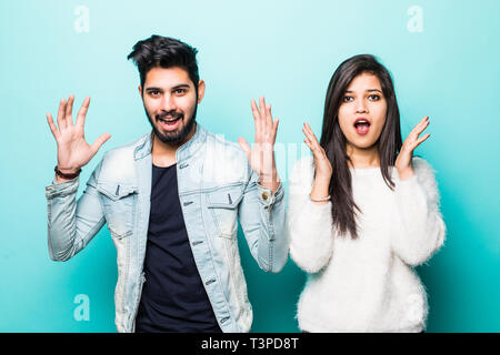 Indian couple scream surprised on green background Stock Photo - Alamy