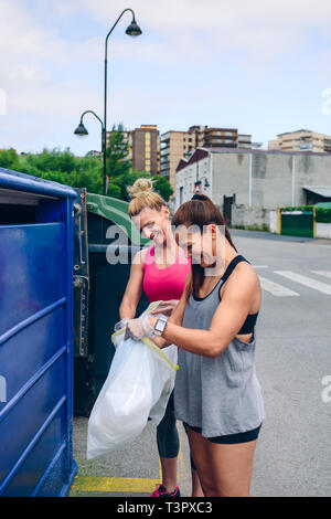 Woman throwing garbage into container. Recycling concept Stock Photo ...