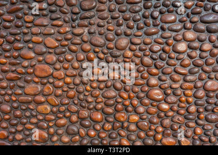 A rustic wall constructed from round polished pebbles and rocks Stock ...
