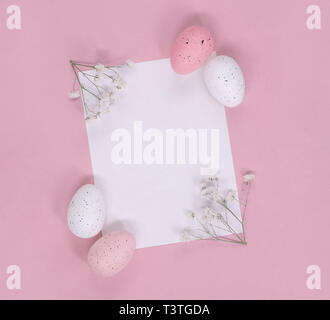 Easter flat lay on pink paper with quail eggs, blank greeting cards and ...