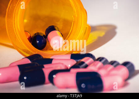 Close up of pink and blue Amoxicillin antibiotics capsule pills ...