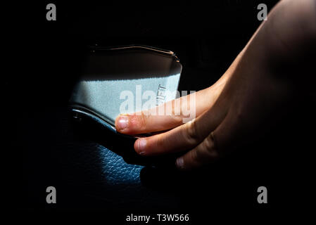 Child's hand on the safety latch of an airplane belt Stock Photo - Alamy