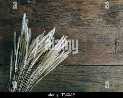 dry grass flower on wood background Stock Photo - Alamy