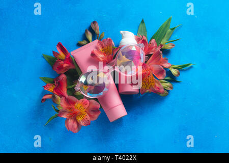 Flat lay sun protection lotion for kids, sunglasses, sand mold on beige ...