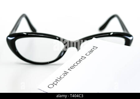 Optical record card with a pair of glasses isolated against a plain ...