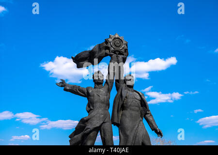 A bronze statue depicting Russian and Ukrainian workers holding up the ...