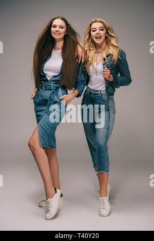Blonde woman models a trendy denim outfit, expressing youth culture and ...