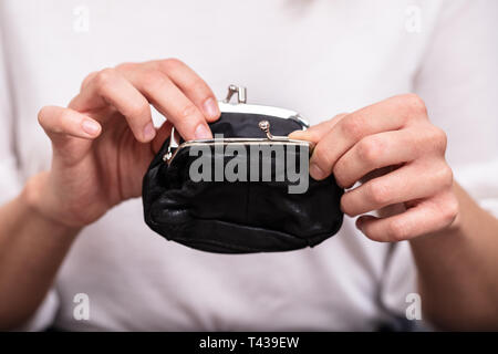 A person's woman's hand holding a purse open with money sterling Stock ...