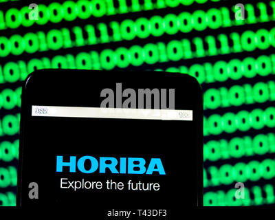 In this photo illustration a Horiba, Ltd. logo seen displayed on a ...