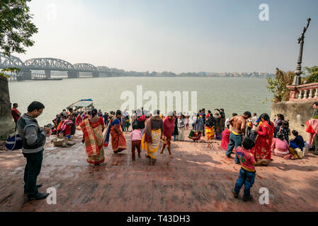 Hindu pilgrims at the Dakshineswar Ganga Ghat along the Hooghly River ...