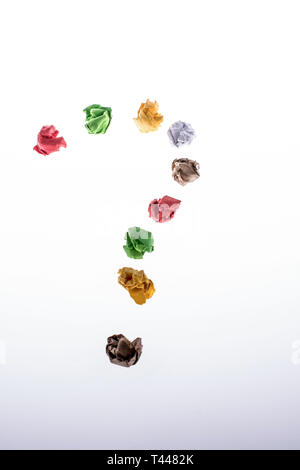 Colorful crumpled paper form a question mark on a white background ...