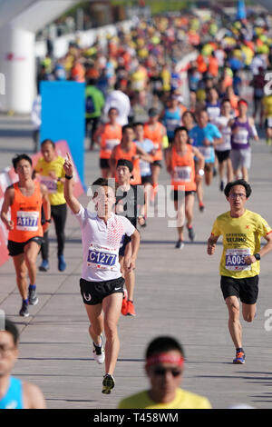Beijing, China. 14th Apr, 2019. Participants run from the starting line ...