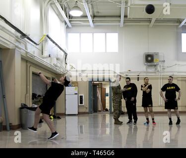 Soldiers complete the standing power throw portion of the Army Combat ...