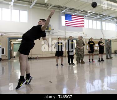 Soldiers complete the standing power throw portion of the Army Combat ...