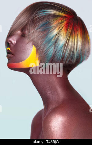 Beautiful girl with multi-colored hair and creative make up and ...
