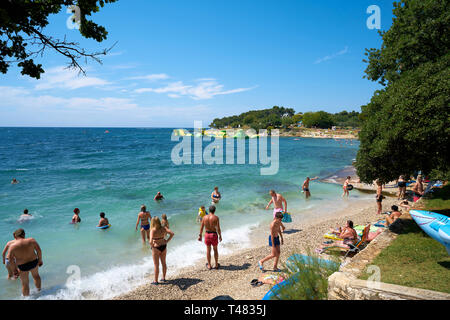 Tourists on the beach in Porec in Croatia Stock Photo - Alamy