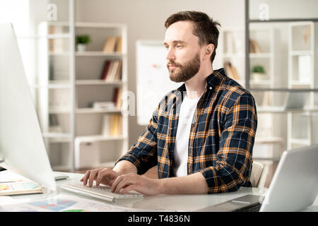 Young handsome designer working at the project Stock Photo - Alamy