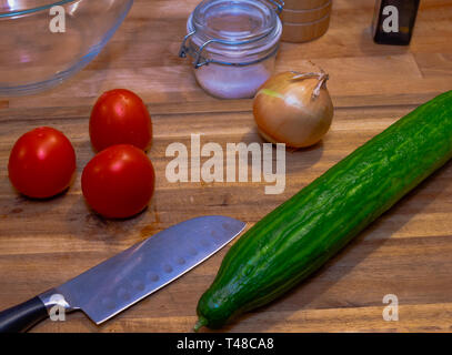 Vegetables for salad, knife and cutting board on the table. Preparation ...
