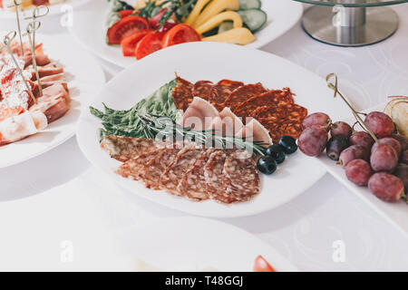 slices of sausage grapes on the festival table Stock Photo - Alamy