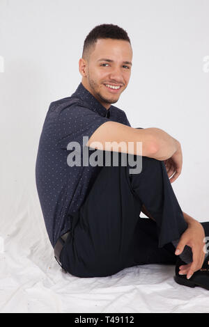 Handsome man sitting with a big smile Stock Photo - Alamy