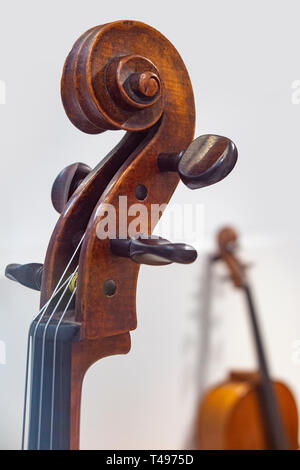 Cellos in a white room Stock Photo - Alamy