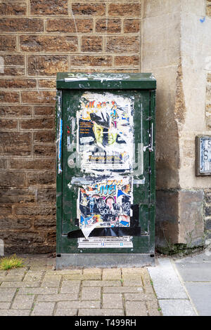 Advertising posters and flyers on a British Telecom cable junction box ...
