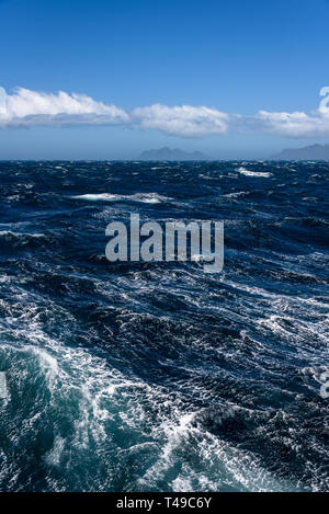 View of Atlantic Ocean and distant mountains, choppy water, calm blue ...