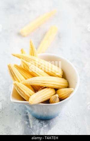 Fresh young baby corn on grey concrete background. Space for text Stock ...