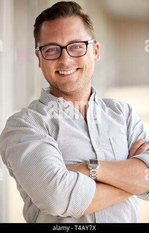 smiling tutor man in glasses with laptop. adult student study online ...