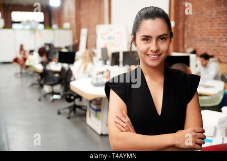 Confident businesswoman working at a modern office, using a laptop ...