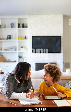 Black teen girl doing homework at home writing paper studying Stock ...