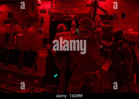 A jumpmaster checks a static line as Paratroopers from 2nd Brigade ...