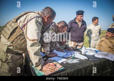 Iraqi soldiers plot coordinates on a map to determine where to adjust ...